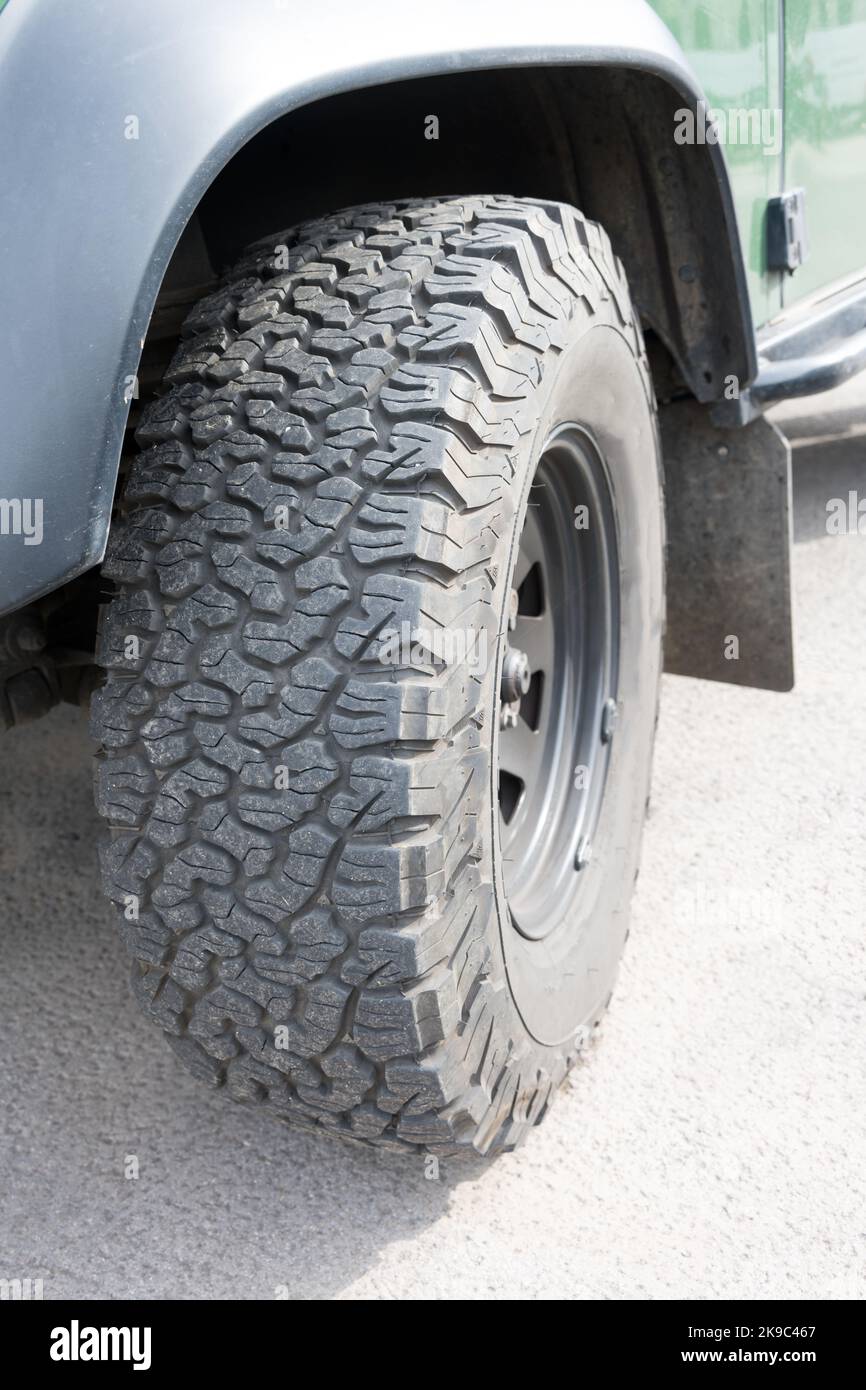 Close up of fender of green edged all terrain car with chunky solid ...