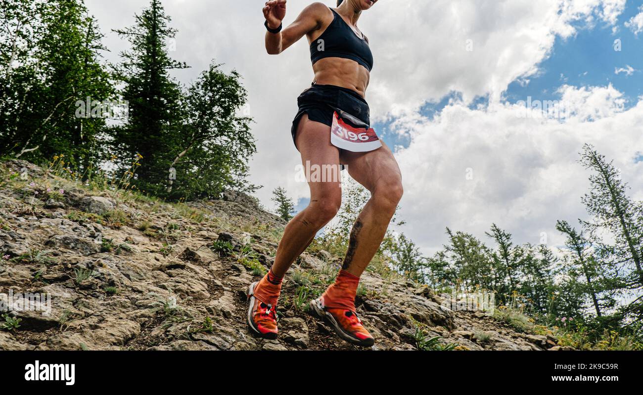 female runner running down mountain trail Stock Photo - Alamy