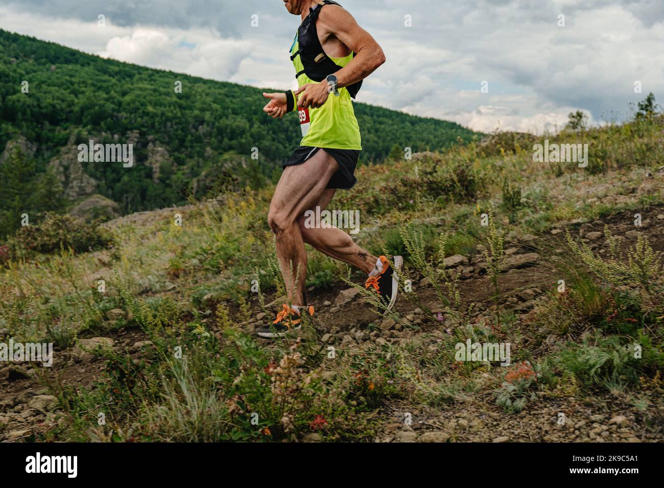male runner running down mountain trail Stock Photo - Alamy