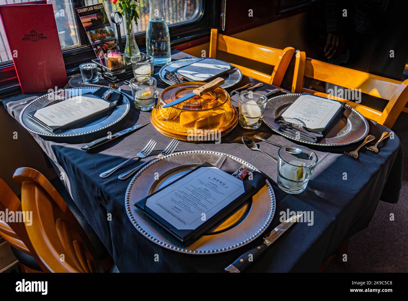 gourmet dinner served while beautiful Vermont landscape rolls by window ...