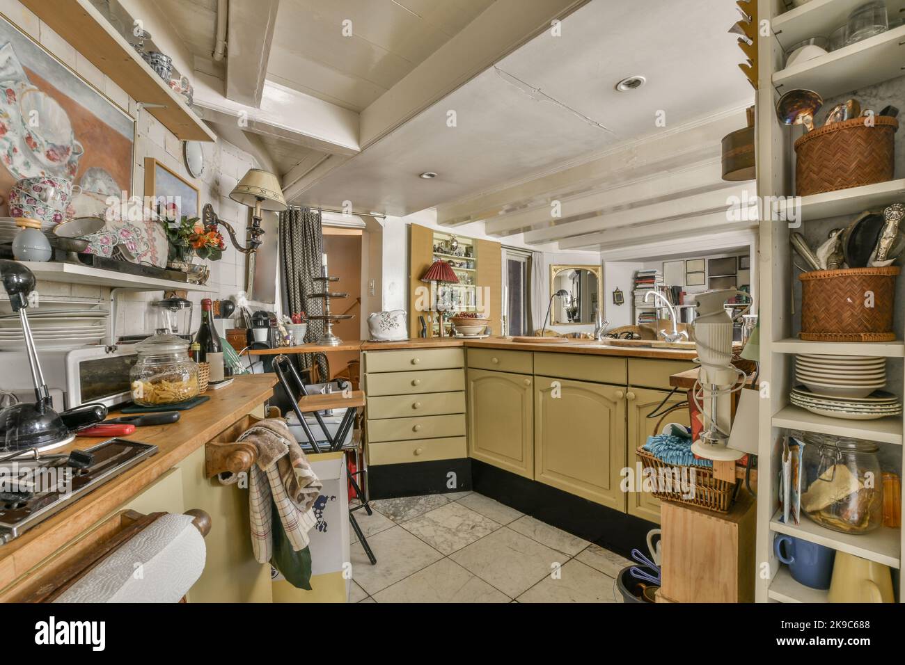 Table with chairs and flowers located near lounge area and kitchen in ...