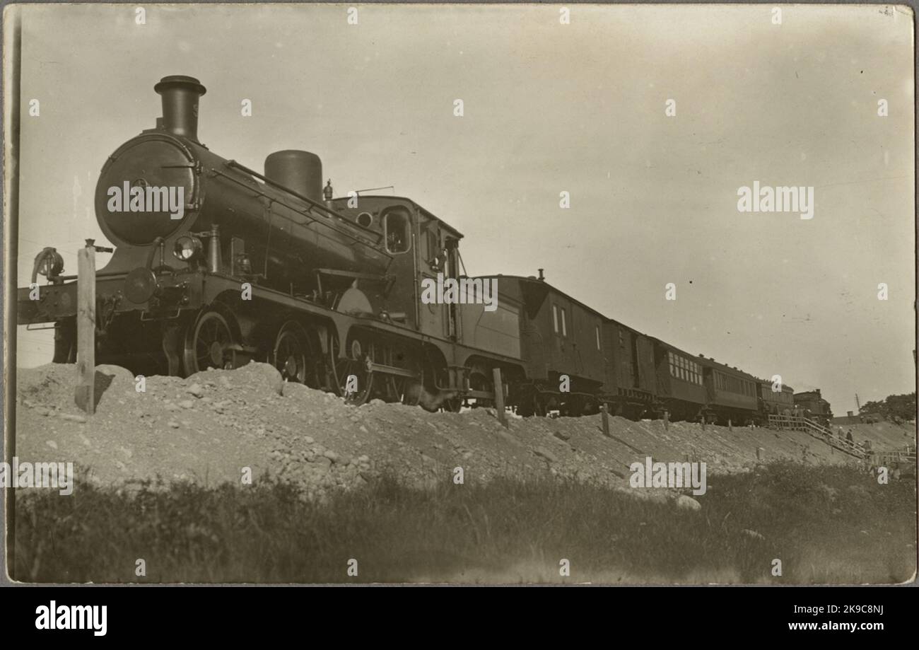 Passenger trains on track with passengers who rise. Steam locomotive ...