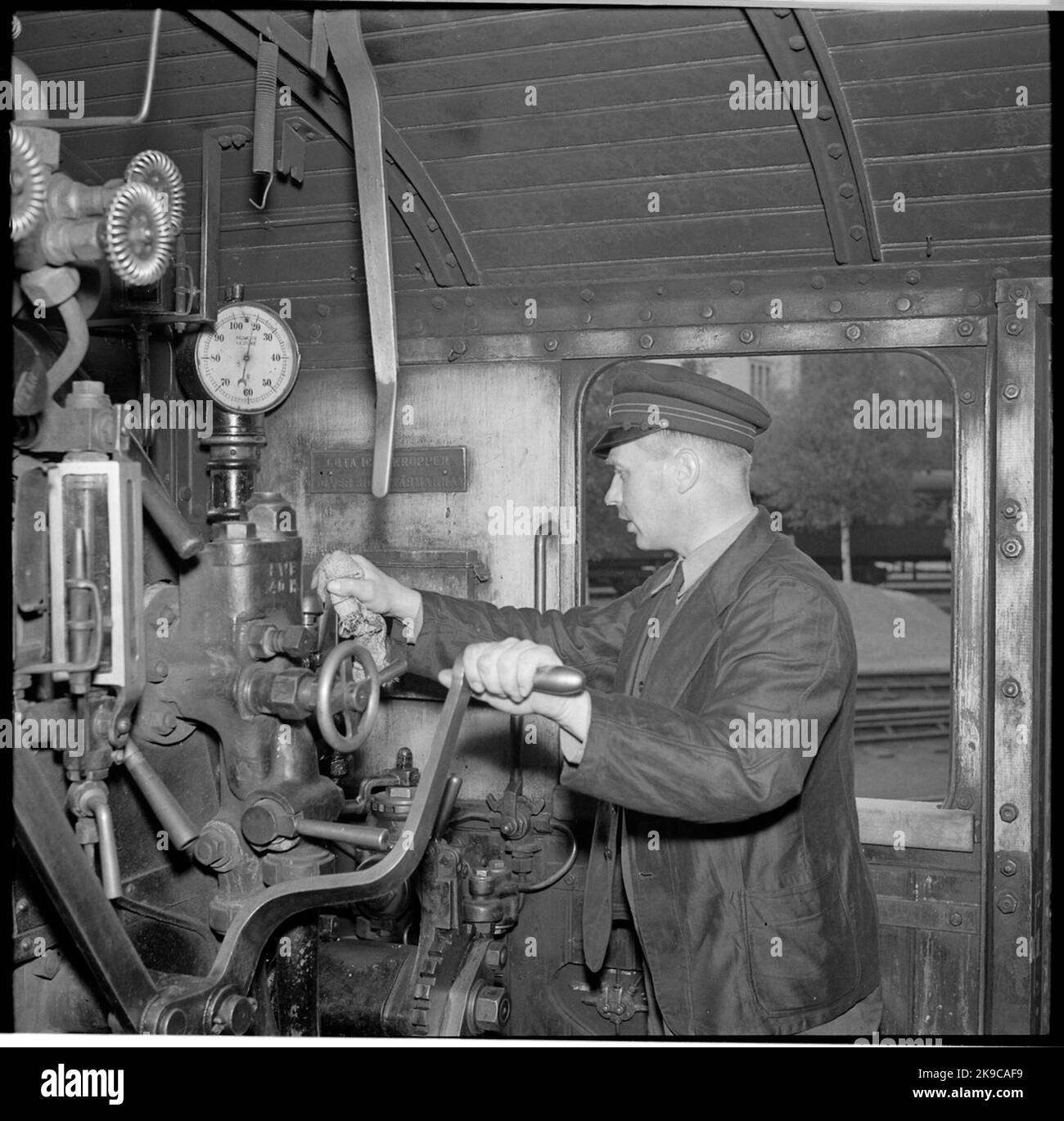 Locomotive staff in locomotive cabin Stock Photo - Alamy