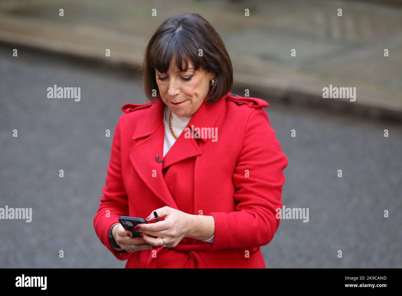 Beth Rigby, SKY political editor looks at her phone in Downing Street ...
