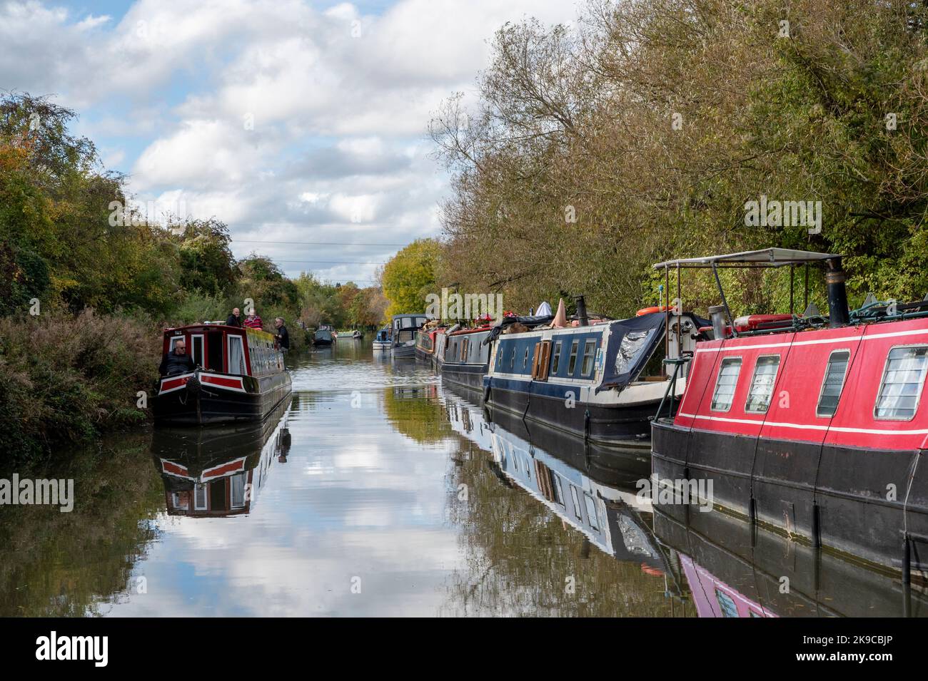 A row of traditional and colourful narrowboats on the Kennet and Avon ...