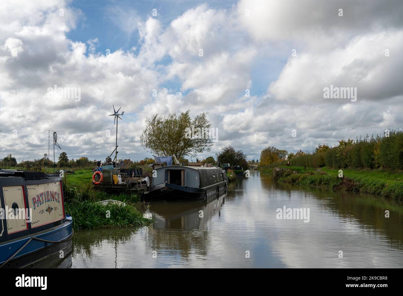 Traditional narrow boats and barges with a small windmill to power ...