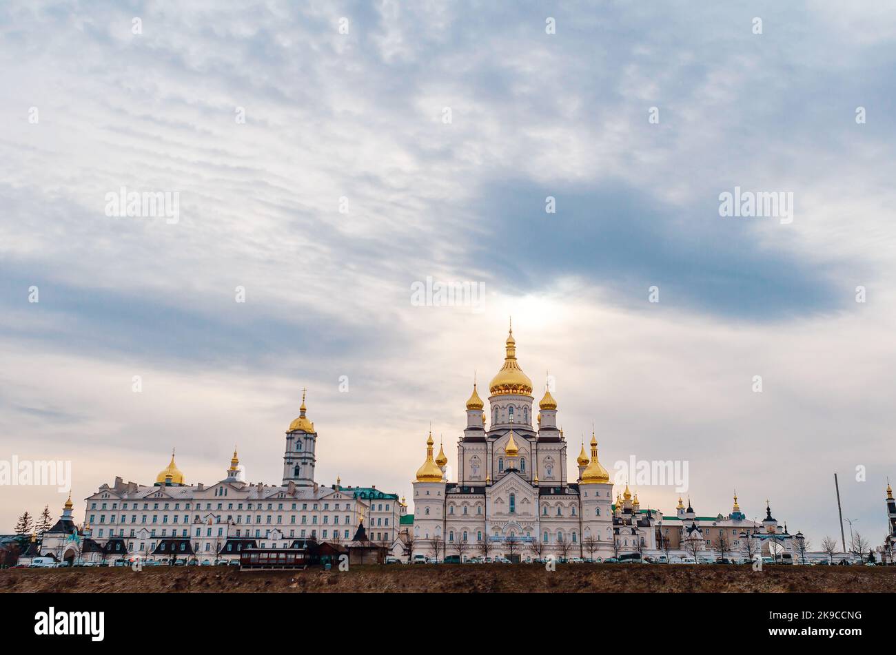 Religious screensaver. Holy Dormition Pochaiv Lavra in Ukraine. Cloudy sky background. Panoramic ...