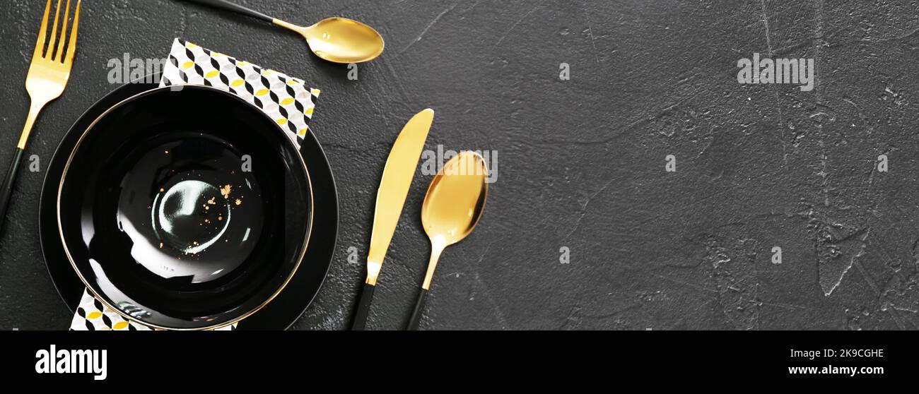 Stylish elegant table setting on dark background with space for text ...