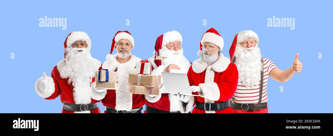 Many Santa Clauses on light blue background Stock Photo - Alamy