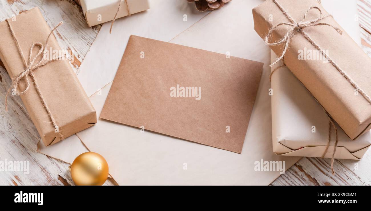 Blank card with gifts on white wooden background Stock Photo - Alamy