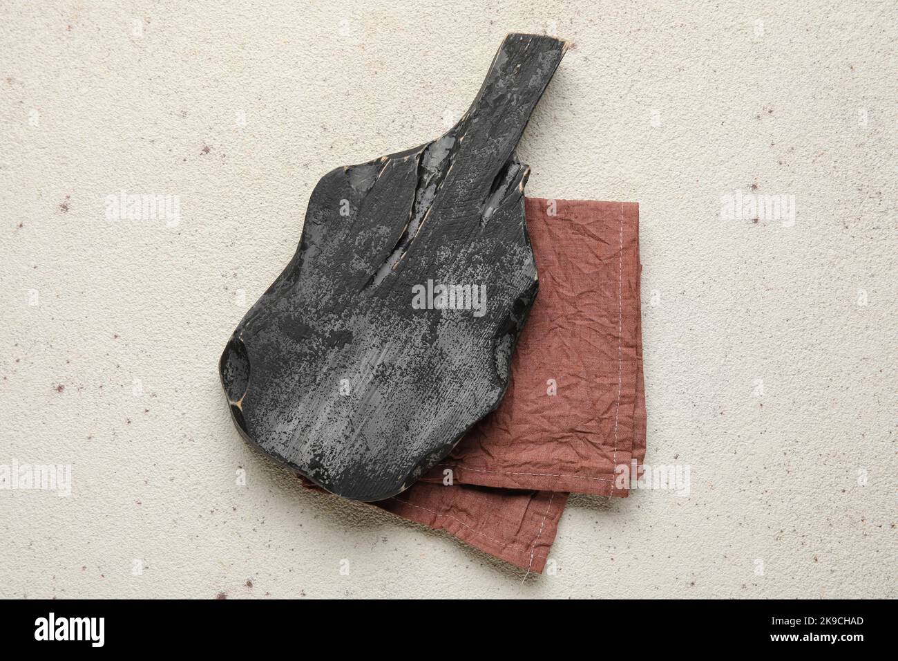 Black wooden cutting board with napkin on white background Stock Photo ...