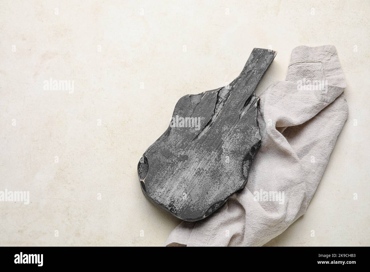 Black wooden cutting board with napkin on white background Stock Photo ...