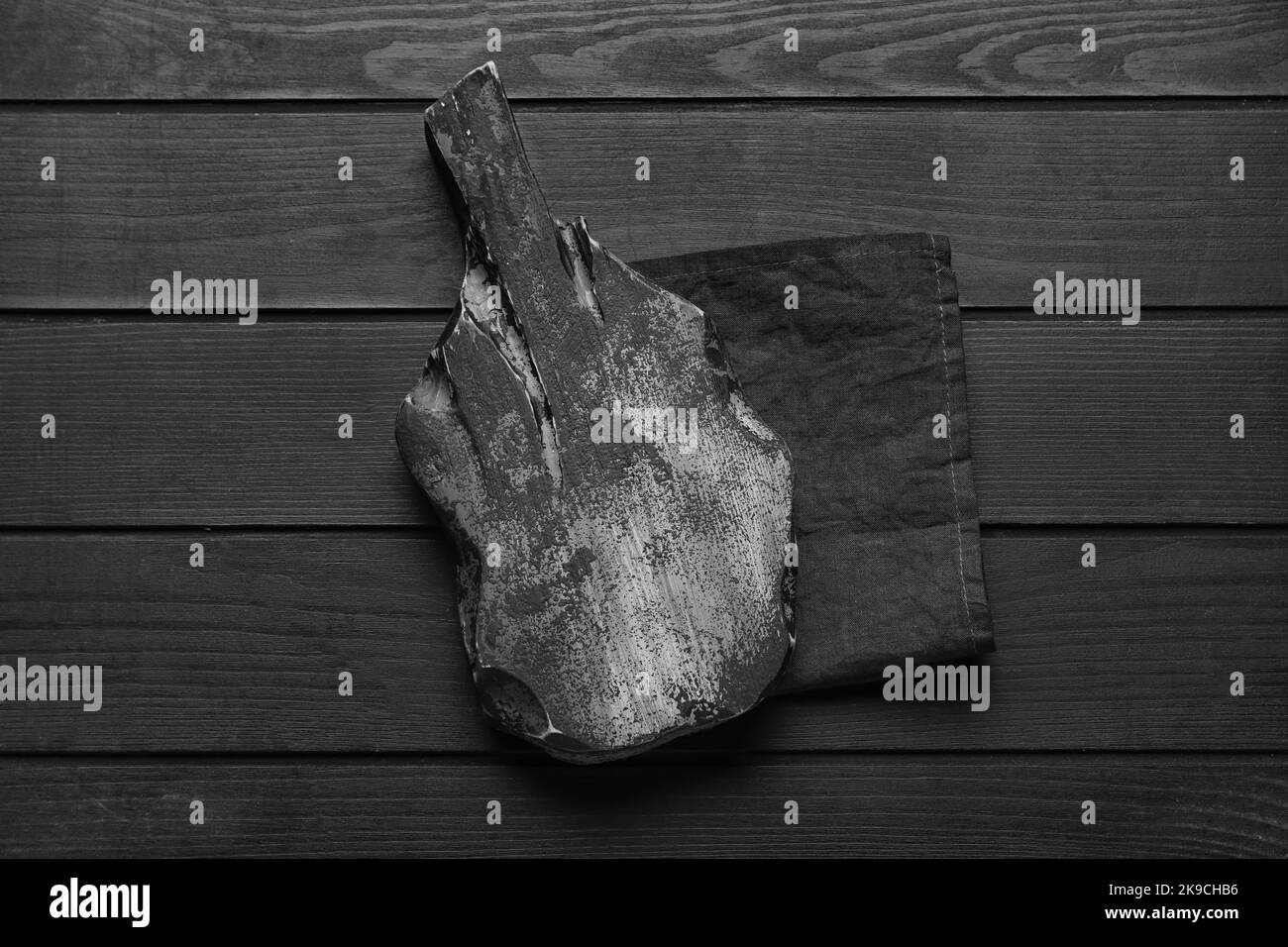 Black cutting board with napkin on dark wooden background Stock Photo ...