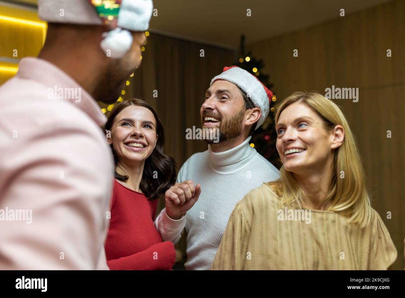 Four diverse friends at New Year's party celebrating and dancing, house ...