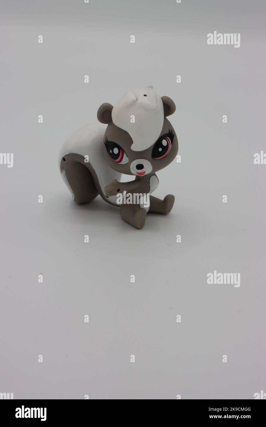 Tiny, cute plastic squirrel animal figure on a white background ...