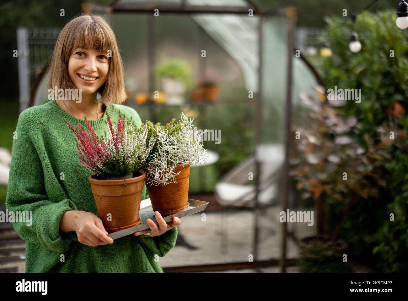 Woman with plants at backyard Stock Photo - Alamy
