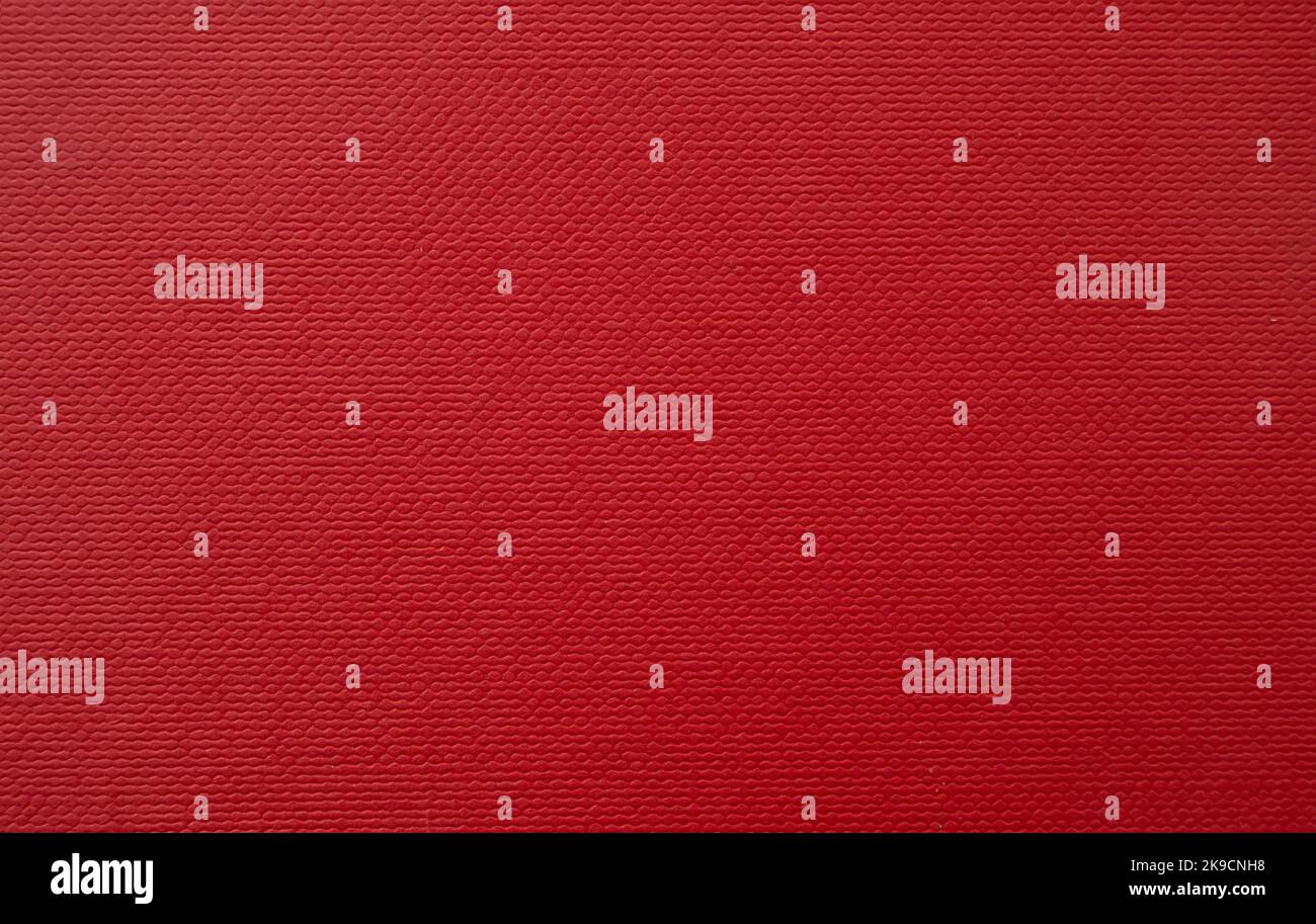 Blank red cardboard with cell pattern as background, bright red surface ...
