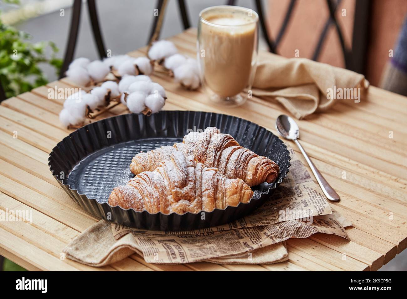 French aesthetic breakfast - powdered croissants with glass of latte ...