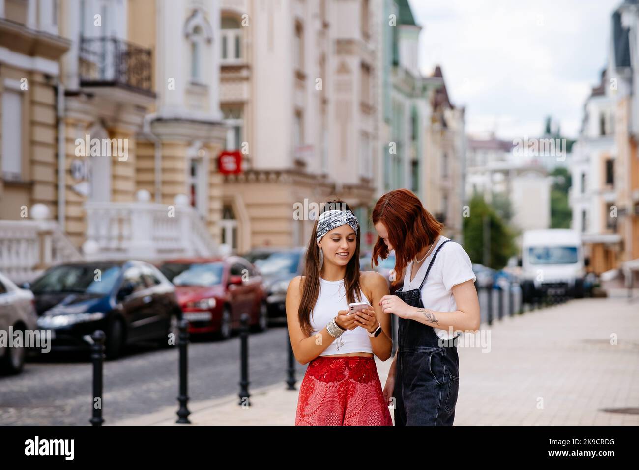 two young women walking outdoor having fun Stock Photo - Alamy