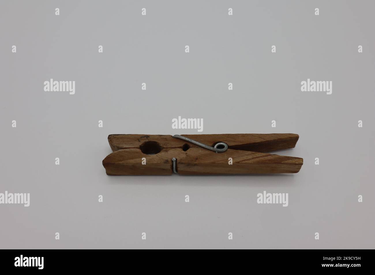 Wooden clothespins or clothes pegs laying on a white background Stock ...