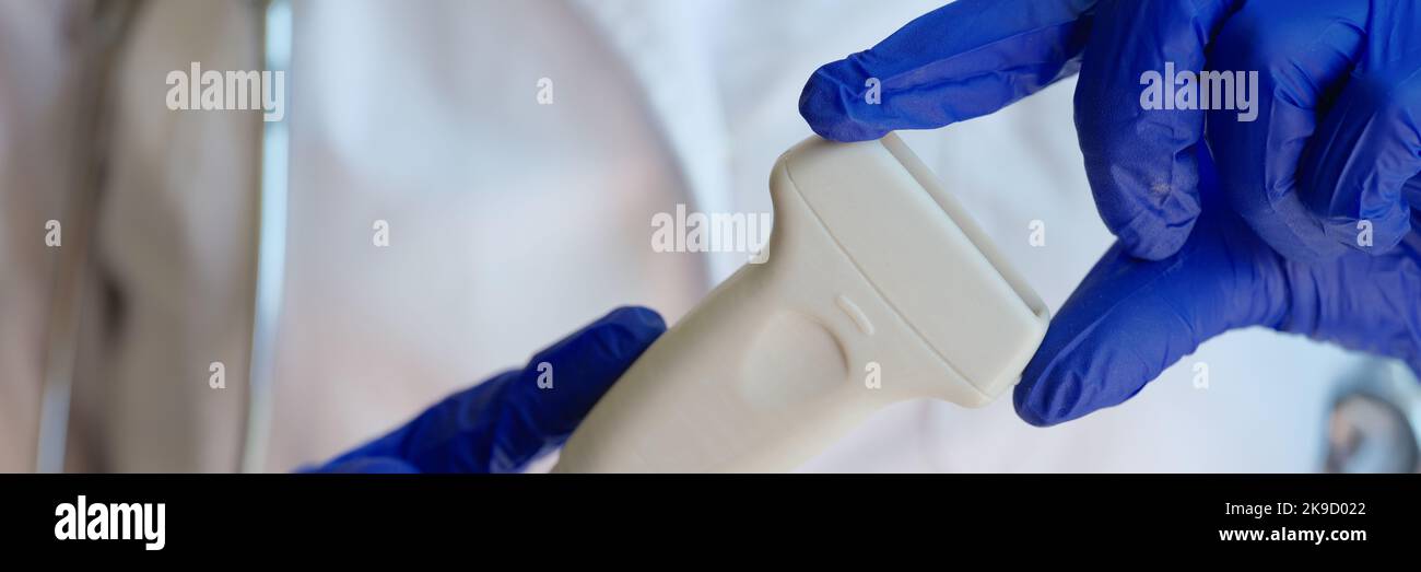 Doctor prepares ultrasound machine for diagnosing patient Stock Photo ...