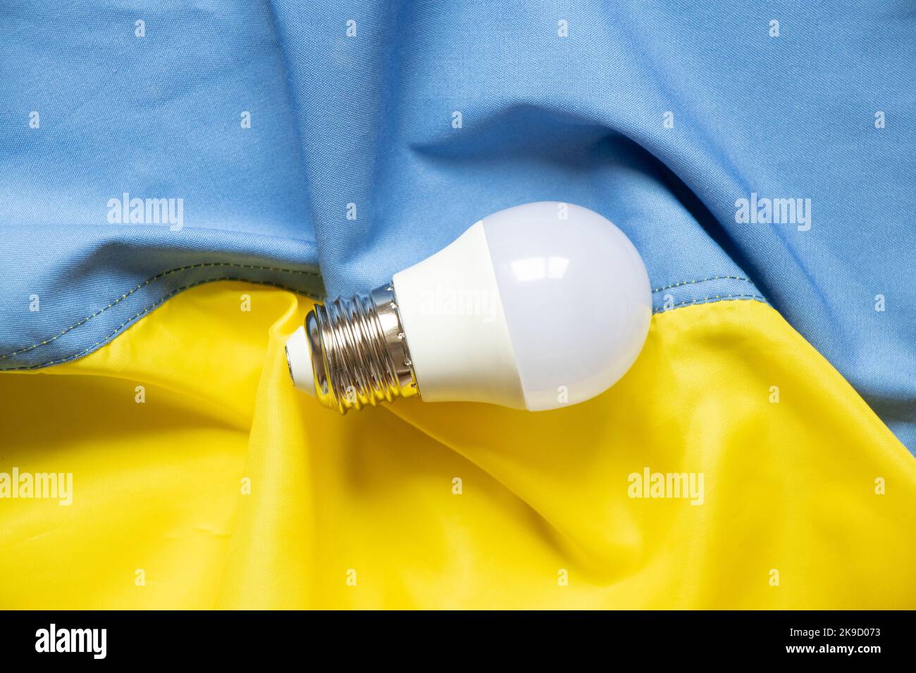 Led lamp lies on the flags of Ukraine, Ukraine without light, energy ...