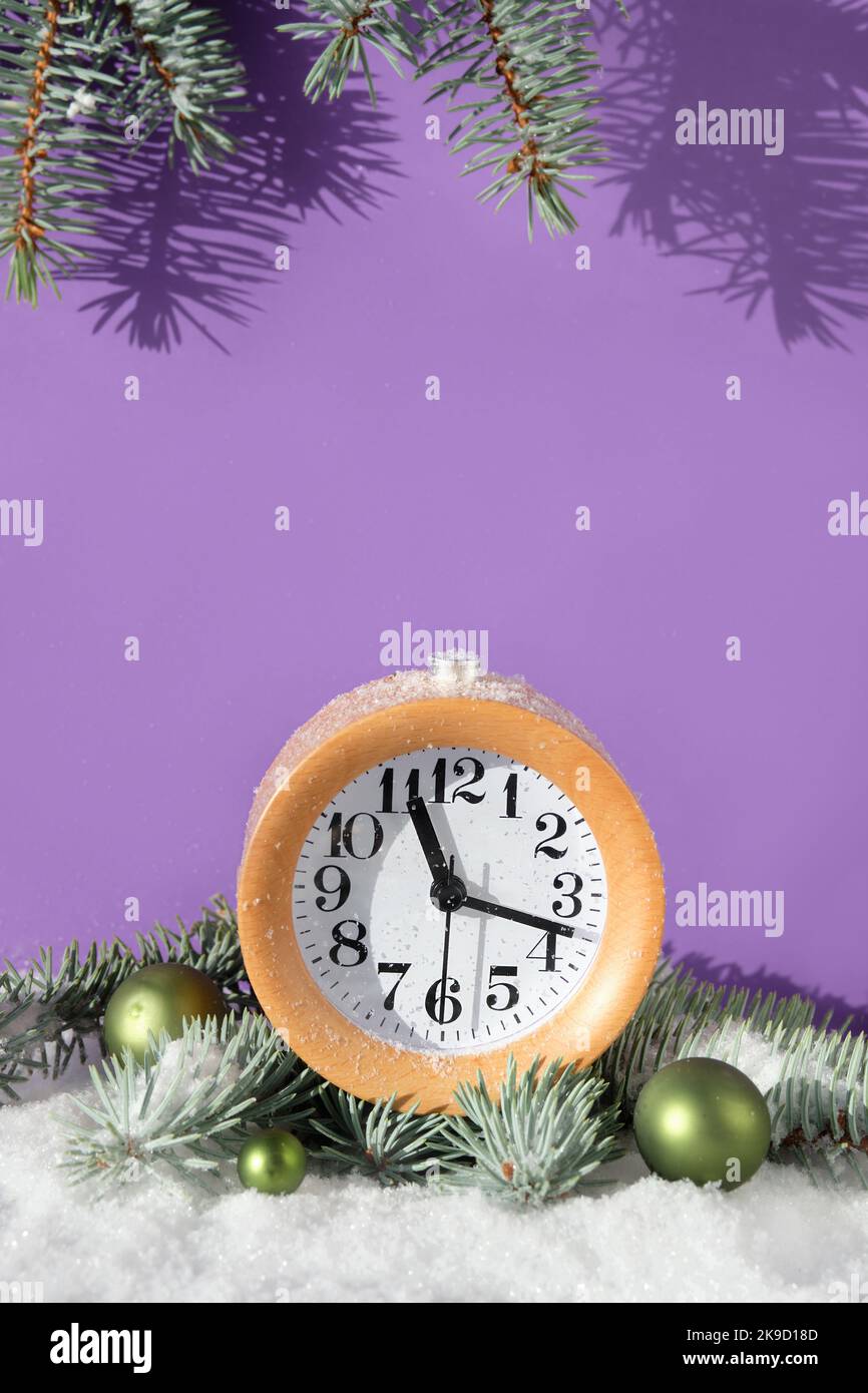 Wood alarm clock with fir twigs and green baubles, balls, trinkets ...