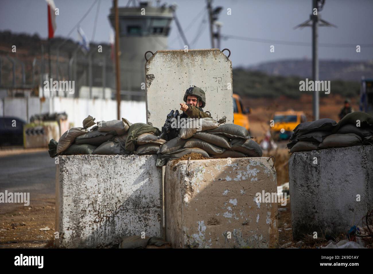 An Israeli soldier seen guarding a military post at an Israeli ...