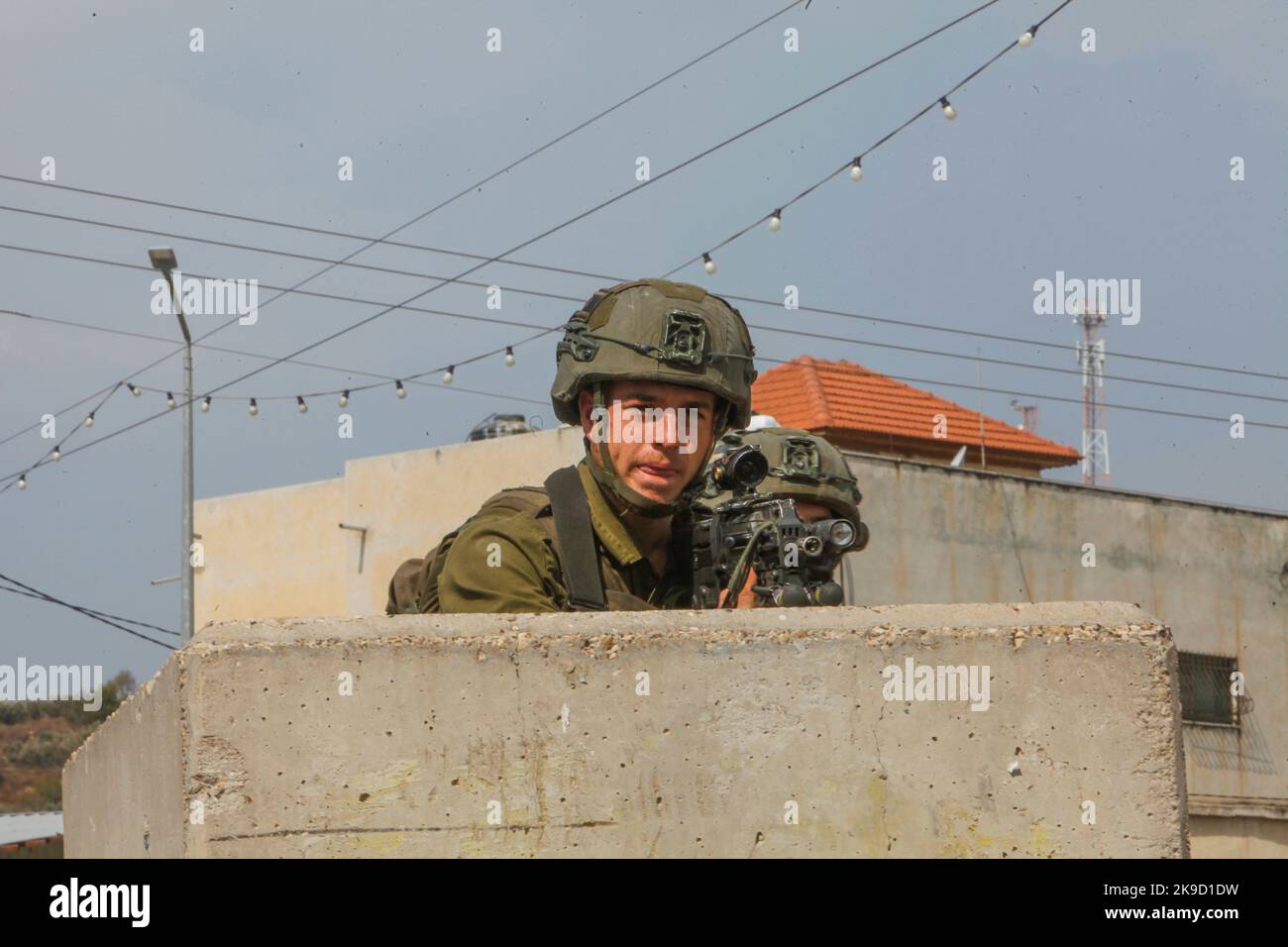 An Israeli soldier seen guarding a military post at an Israeli ...