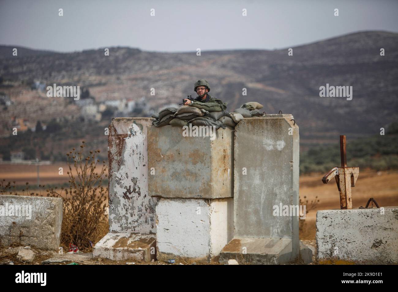 An Israeli soldier seen guarding a military post at an Israeli ...