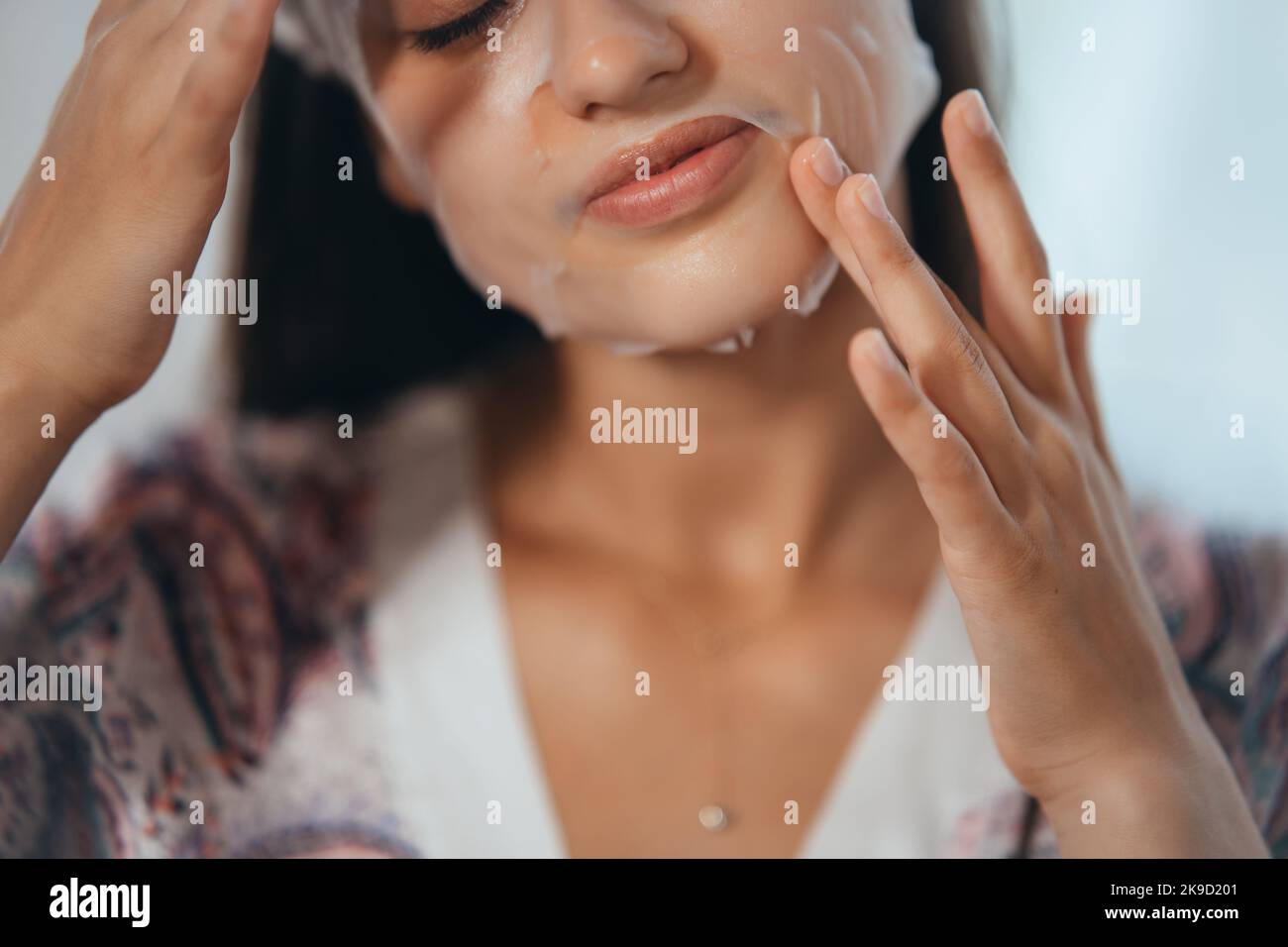 Beautiful model applying cosmetic cream treatment on her face Stock Photo - Alamy