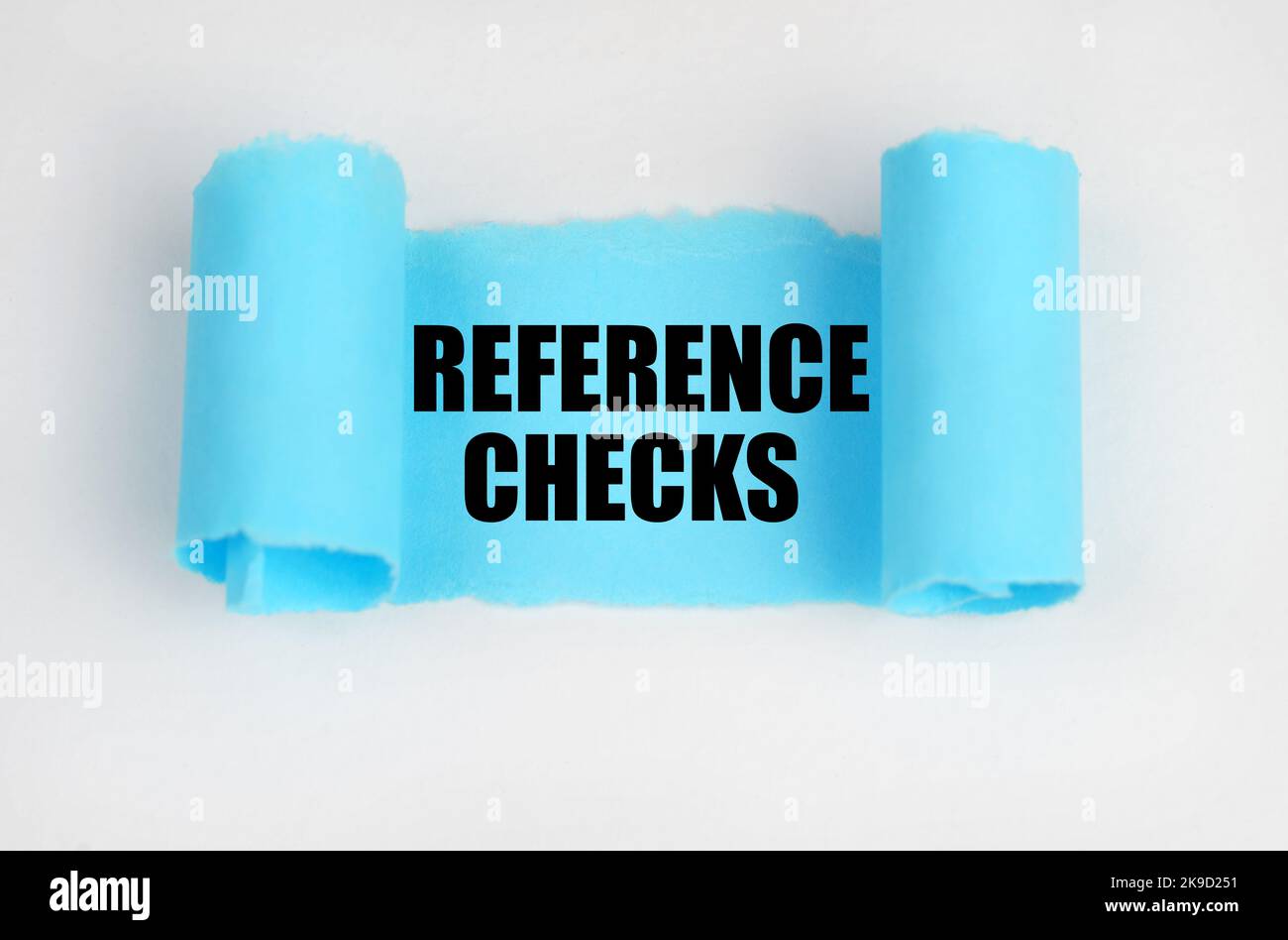 On a white surface, a blue scroll of paper with the inscription ...