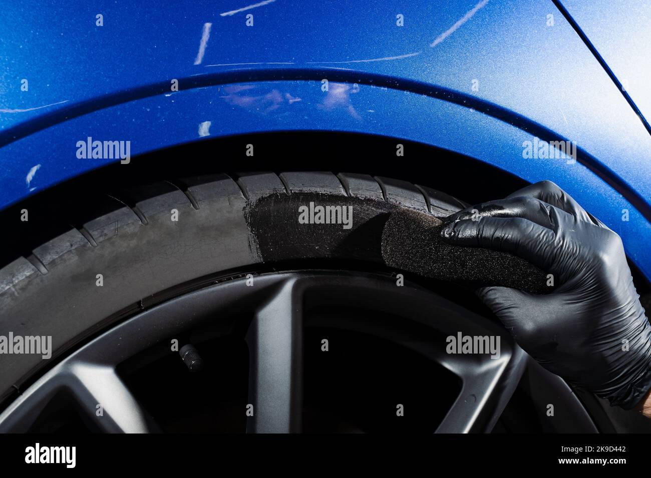 Blackening of tire wheel of car using sponge with chemical blackening ...