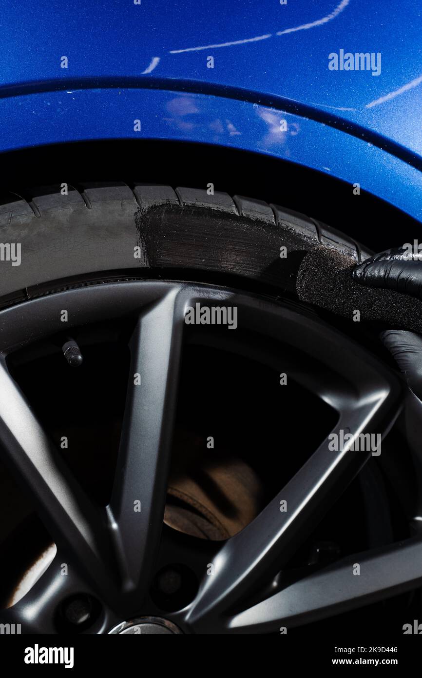 Blackening of tire wheel of car using sponge with chemical blackening ...