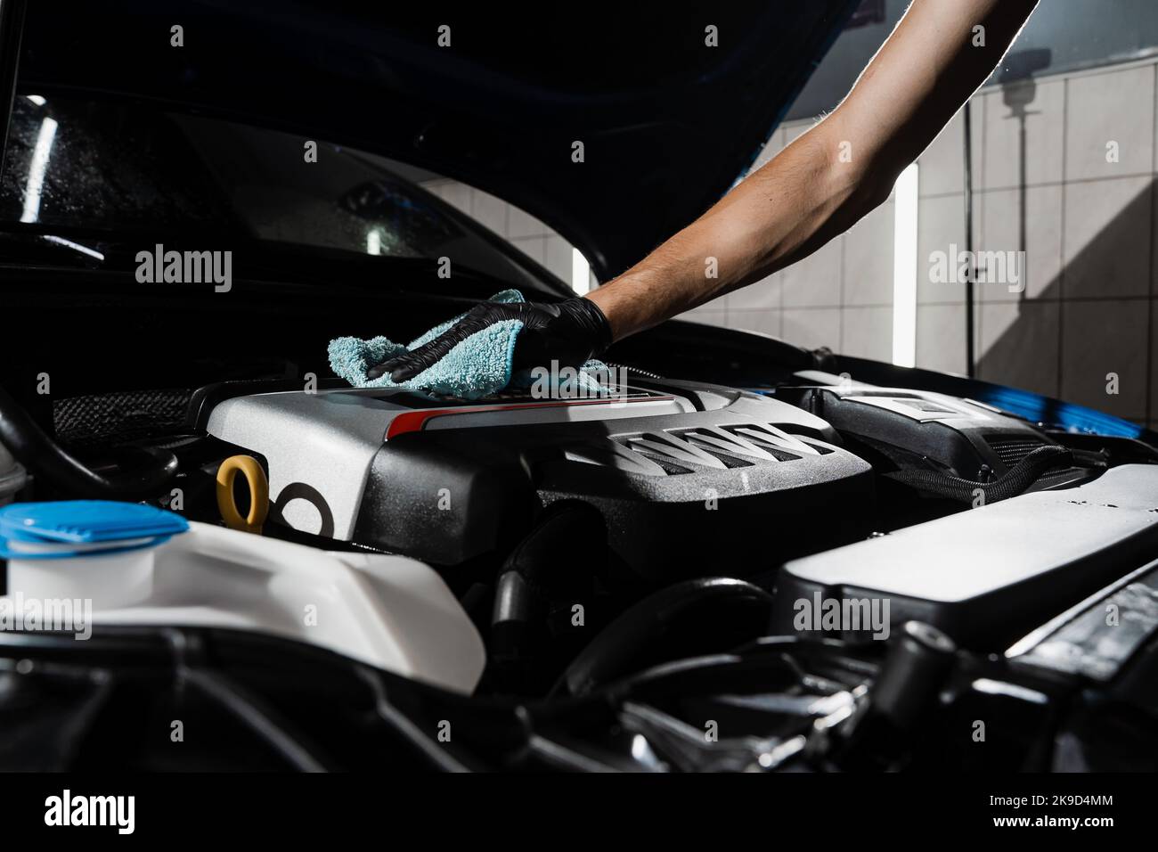 Wiping the car engine with microfiber after washing motor in car ...