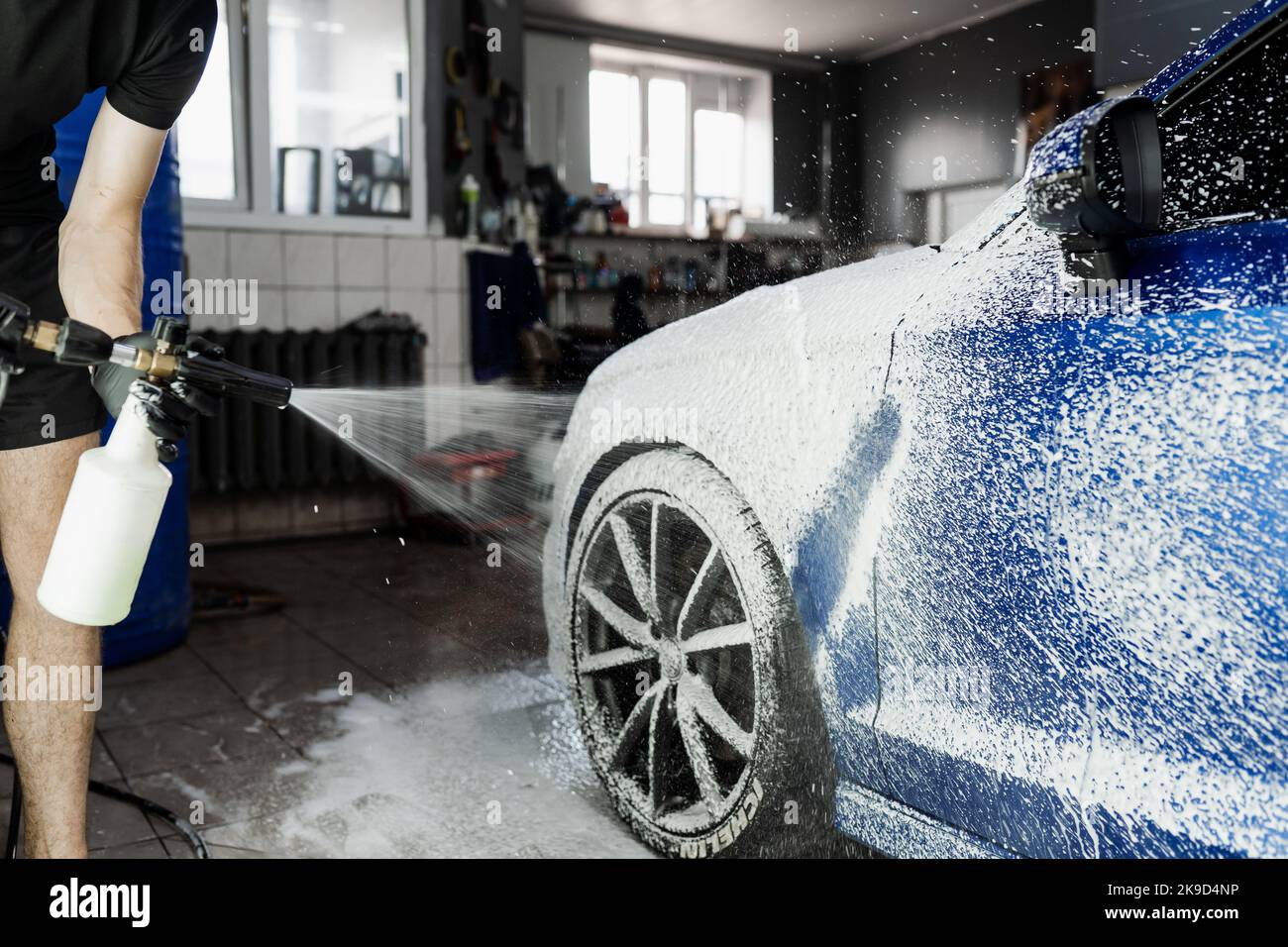 Second phase of detailing washing in car service. Car washer does full ...