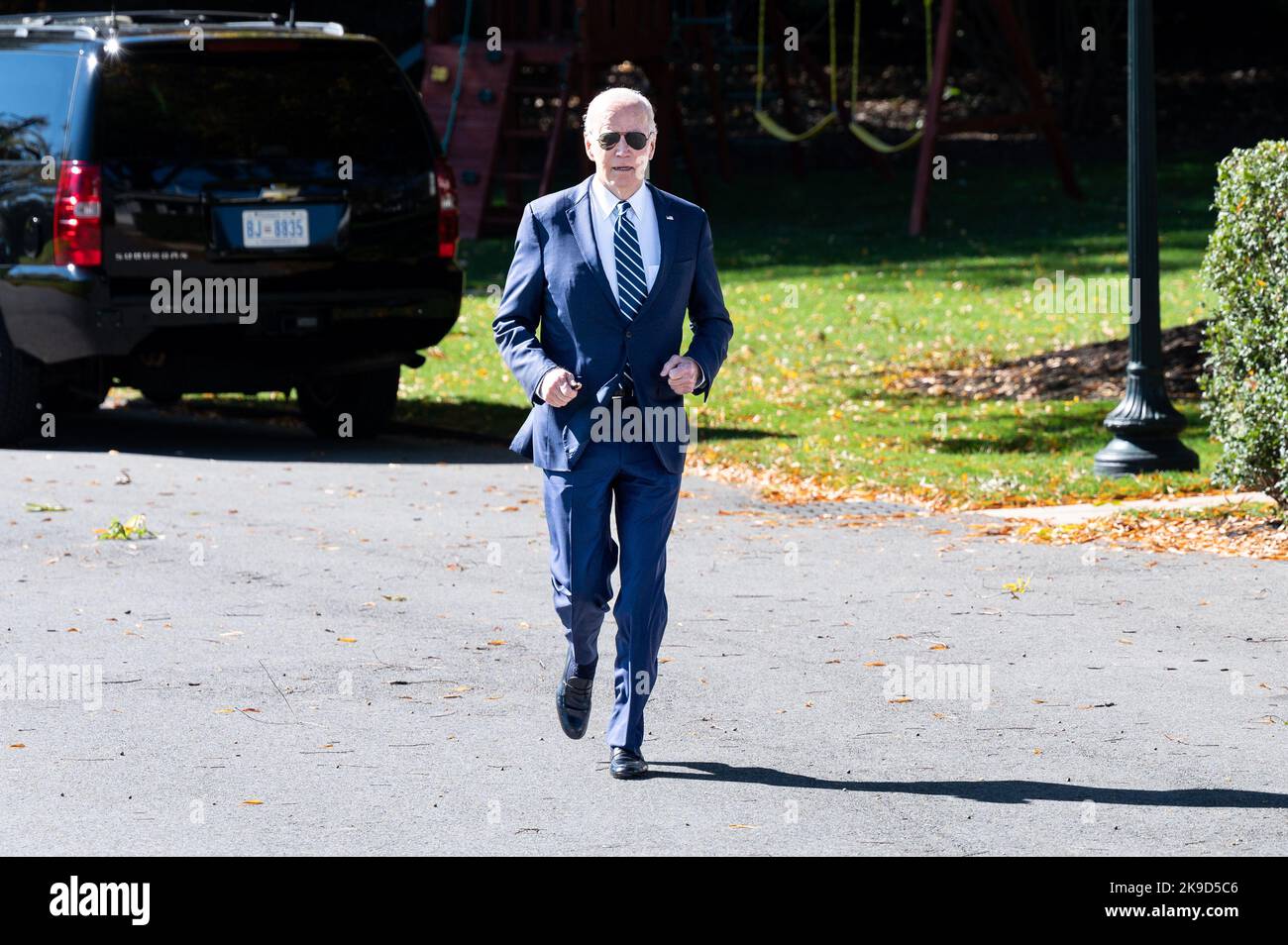 President Joe Biden (D) jogging over to talk to the press before ...