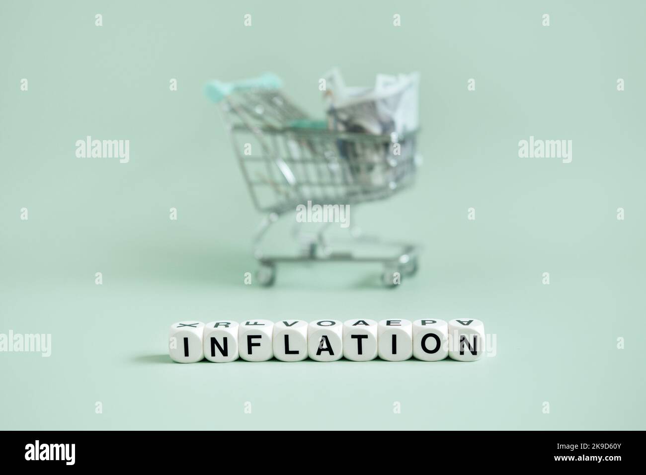 Shopping basket cart with dollars cash and word Inflation on blue ...