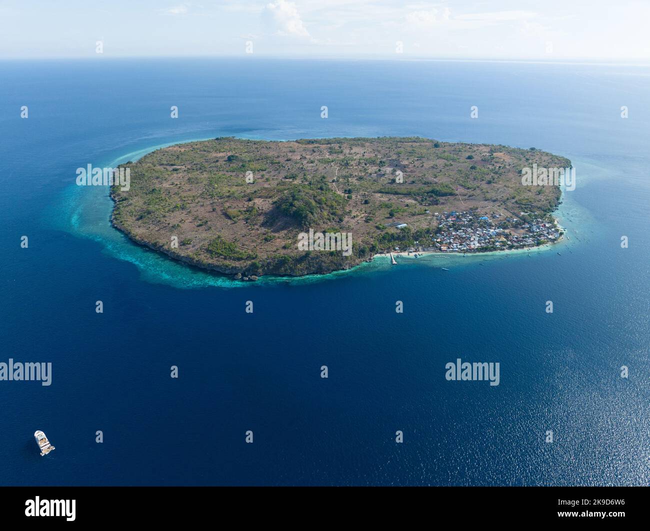 A fringing reef grows along the edge of a remote, tropical island near ...
