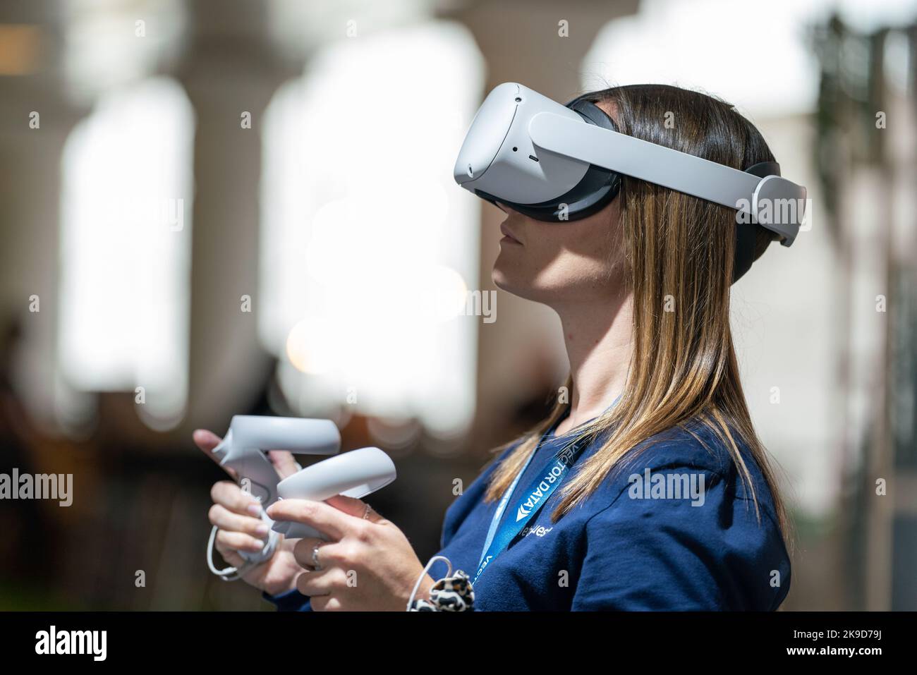 Madrid, Spain. 27th Oct, 2022. A woman wears an Oculus VR Inc virtual reality (VR) headset at ...