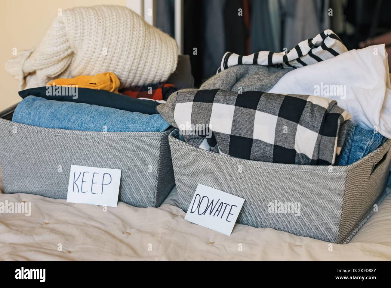 Closet sorting and organization. Two baskets with closes to keep and ...