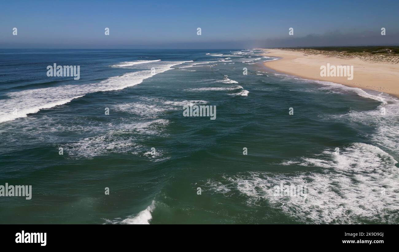 Side view of waves crashing on sandy beach aerial - a bird's eye view ...