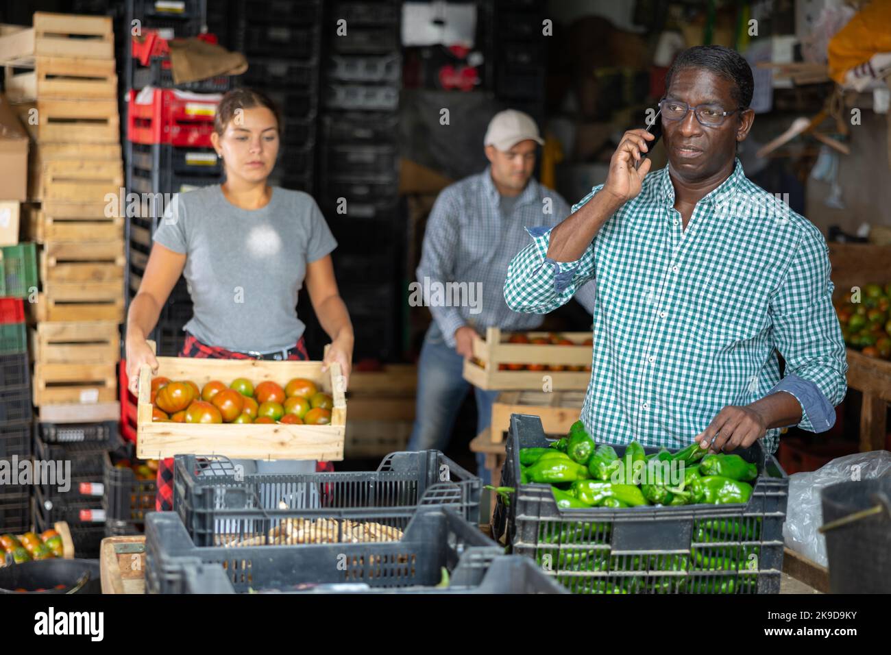Vegetable warehouse manager talking on phone in storeroom Stock Photo ...
