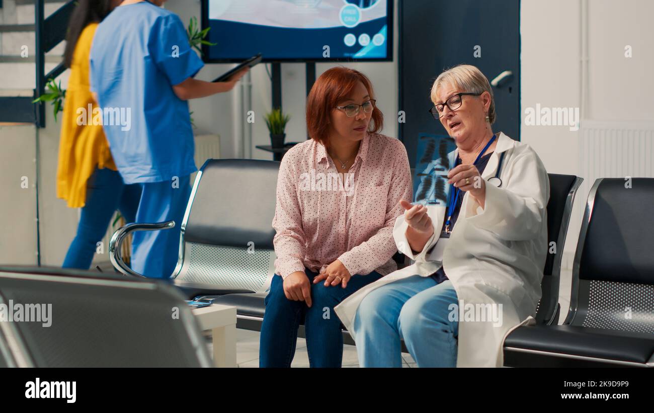 Diverse women looking at bones radiography scan to see diagnosis and ...
