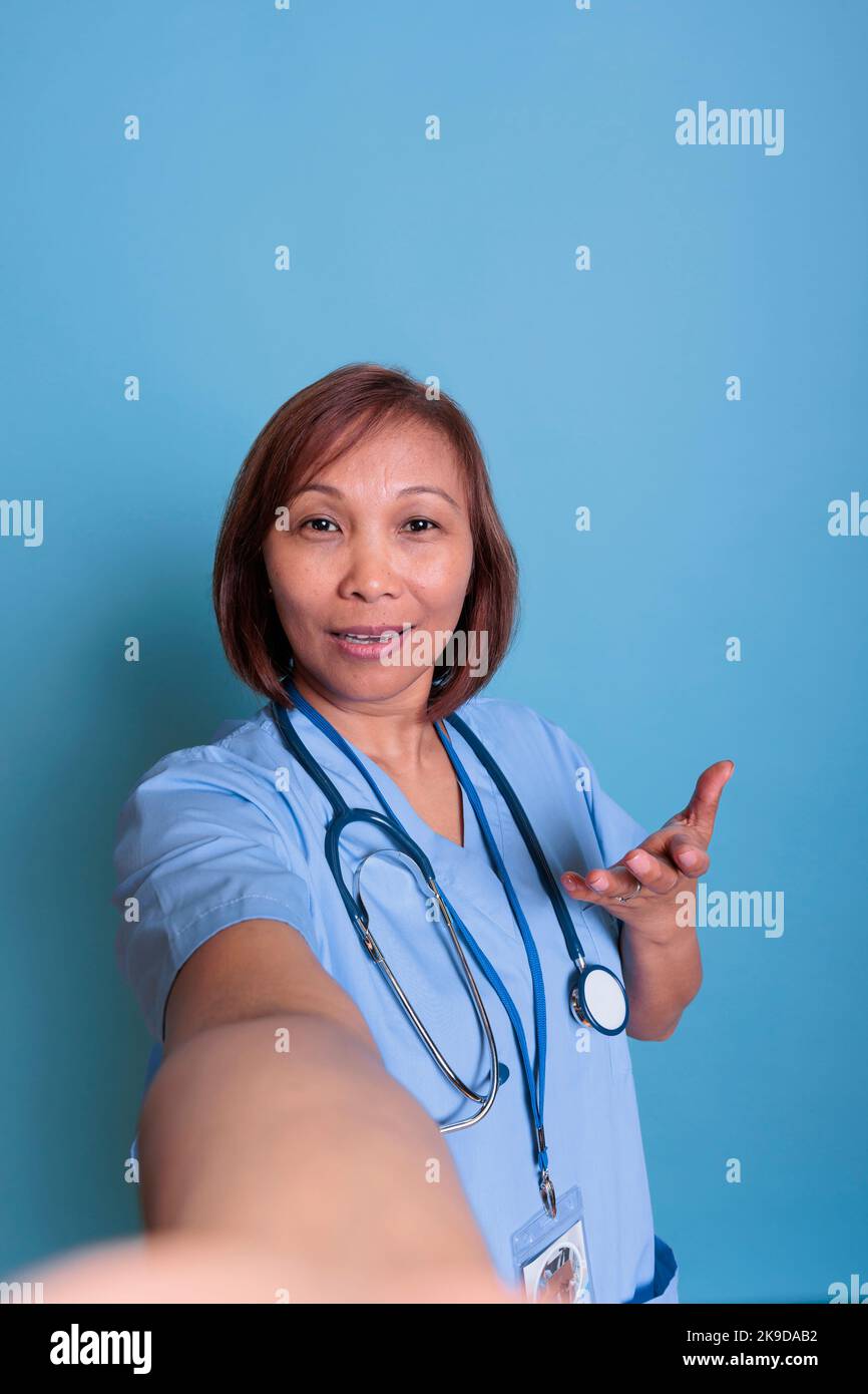 Medical assistant talking with remote practitioner doctor during ...