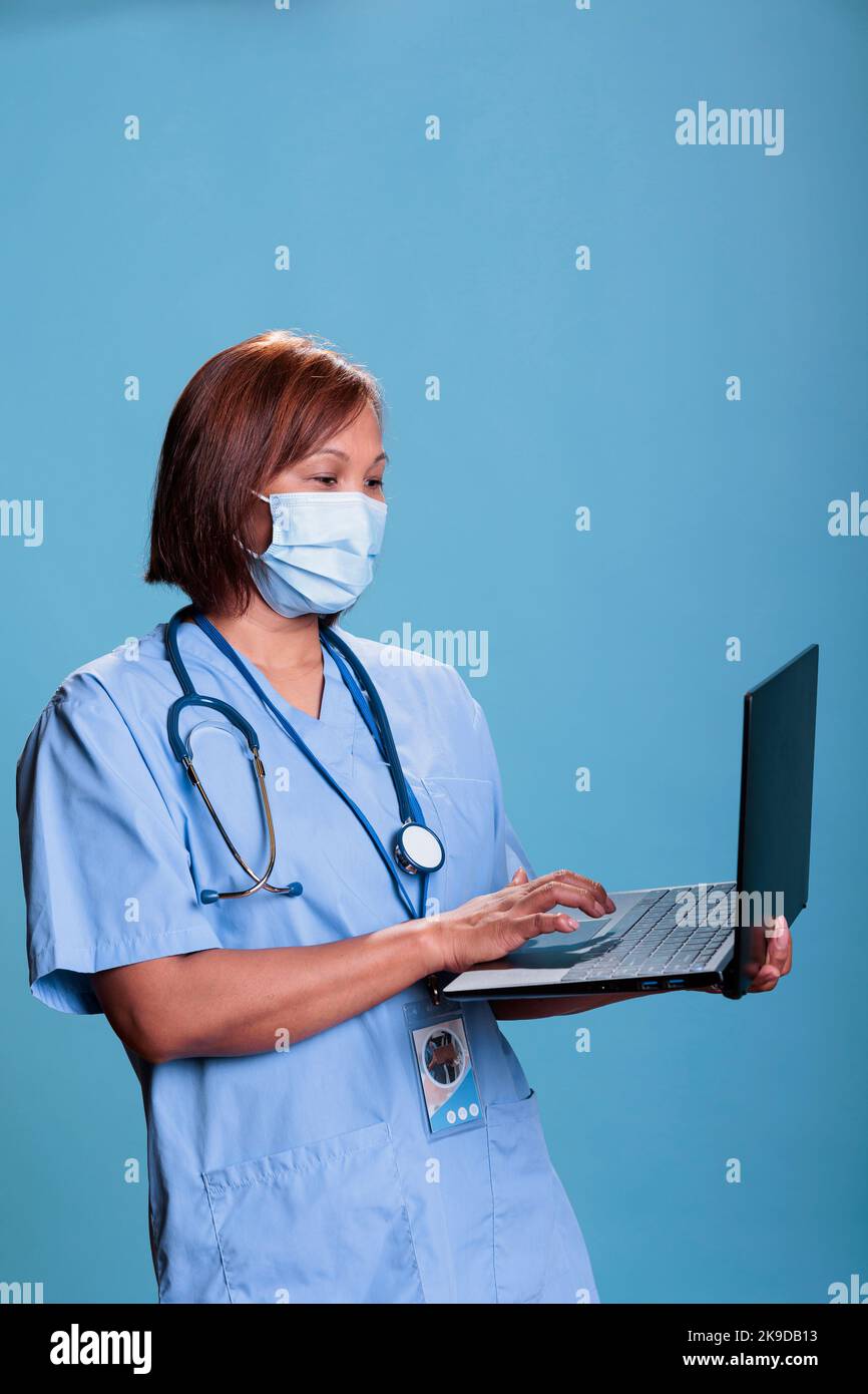 Medical assistant wearing protective face mask to prevent infection ...