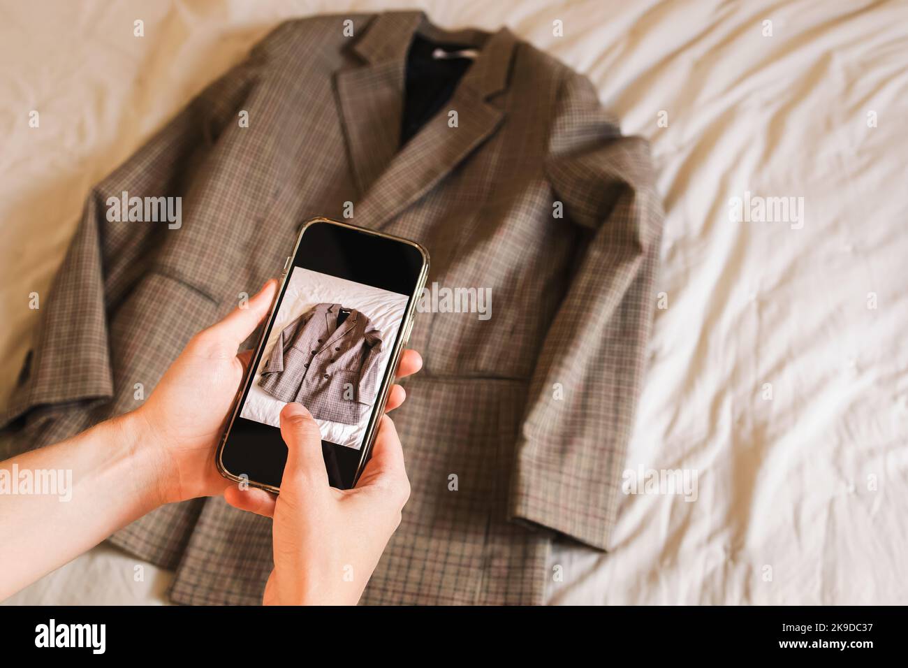 Close-up of woman's hands taking picture of the jacket. Selling used ...