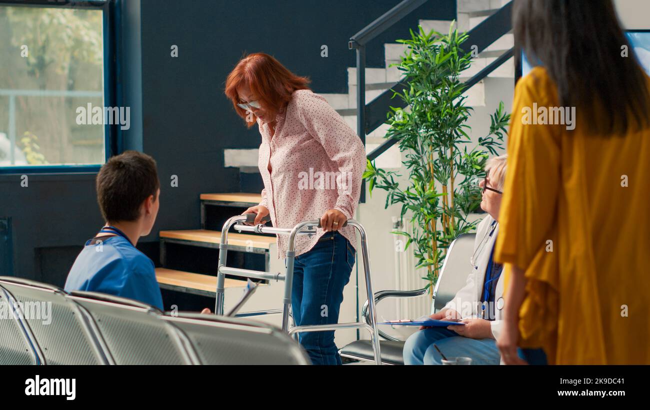 Physician doing physical therapy exam with injured woman, supporting ...