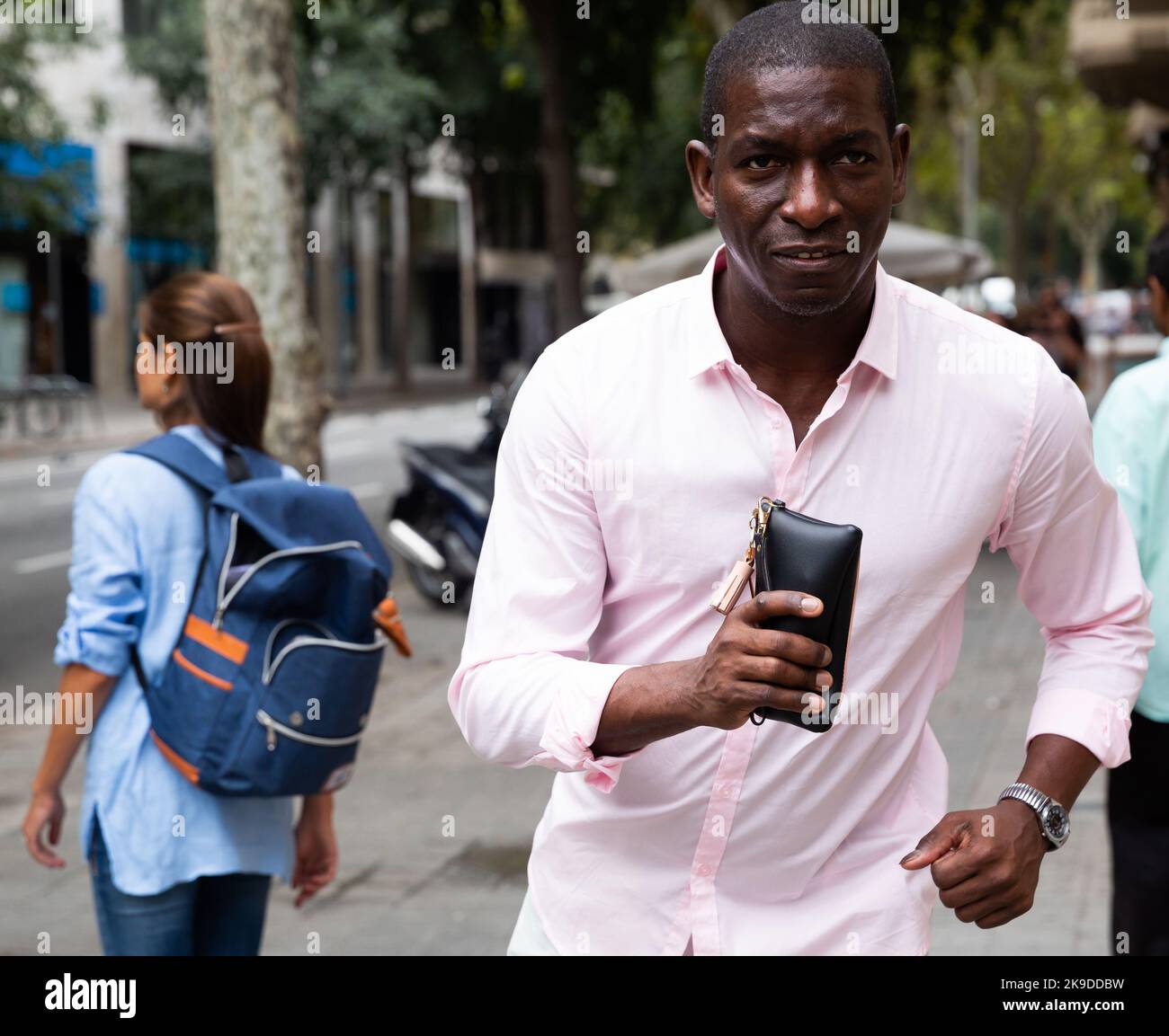 Man running away with stolen wallet Stock Photo - Alamy
