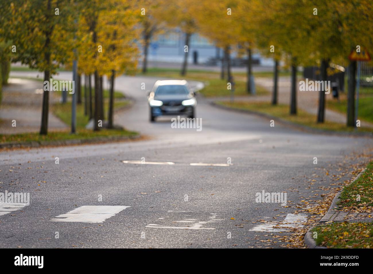 Zebra crossing on a narrow street with car approaching Stock Photo - Alamy